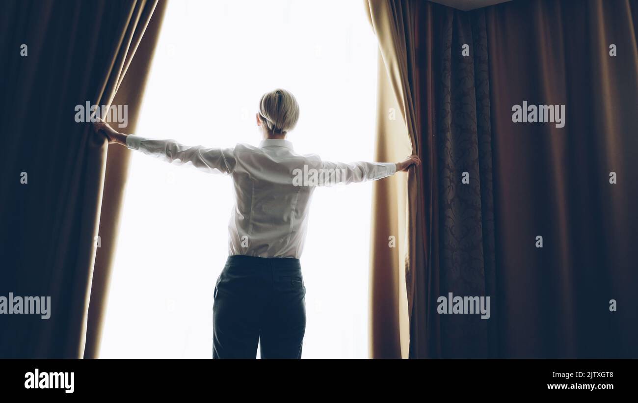 Young pretty woman unveil curtains hi-res stock photography and images ...