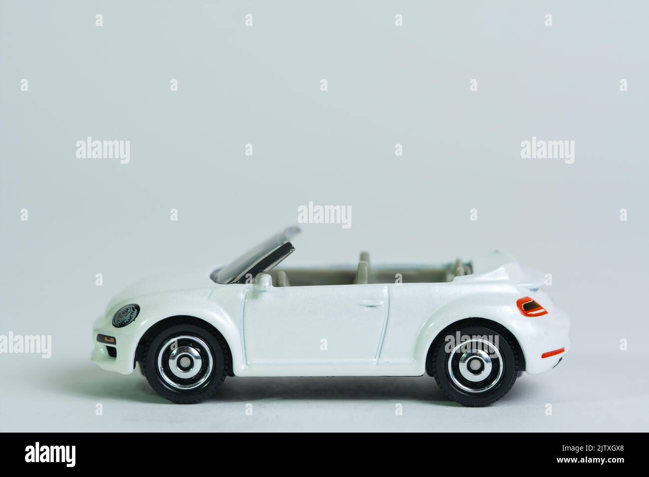 isolated white sporty cabriolet toy car on white background, side view ...