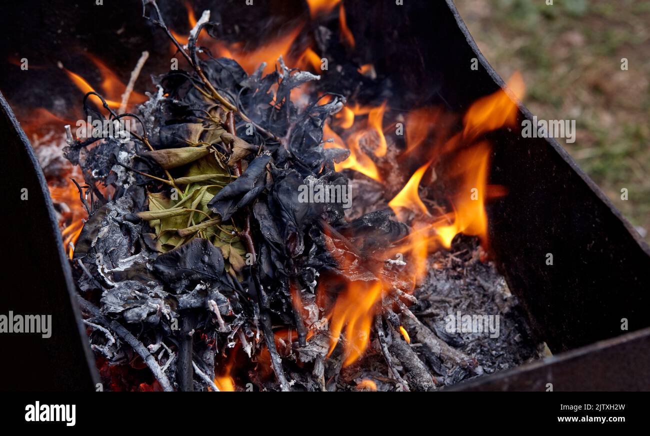 Burning red hot sparks fly from fire. Barbecue gril with glowing and ...