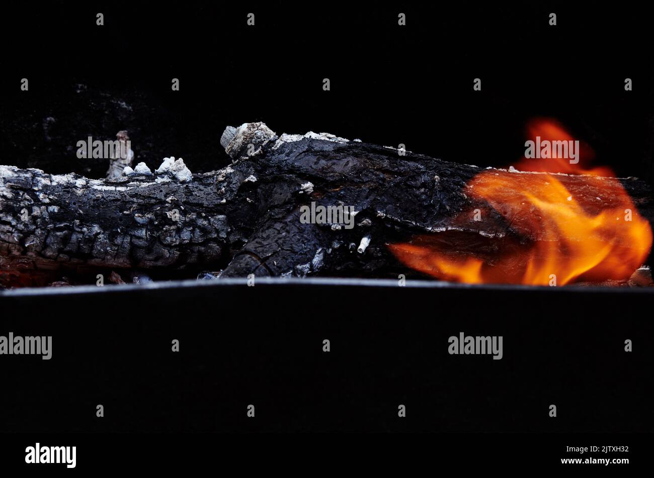 Burning red hot sparks fly from fire. Barbecue gril with glowing and ...