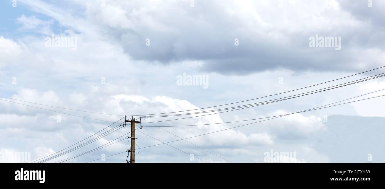Old power pillar on a summer day. Power line post with electricity ...