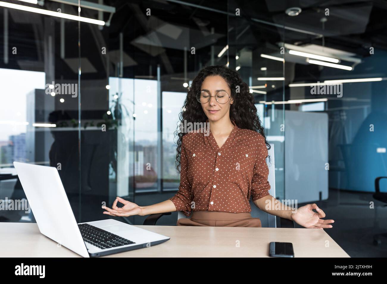 Young beautiful Hispanic web developer working inside office building ...