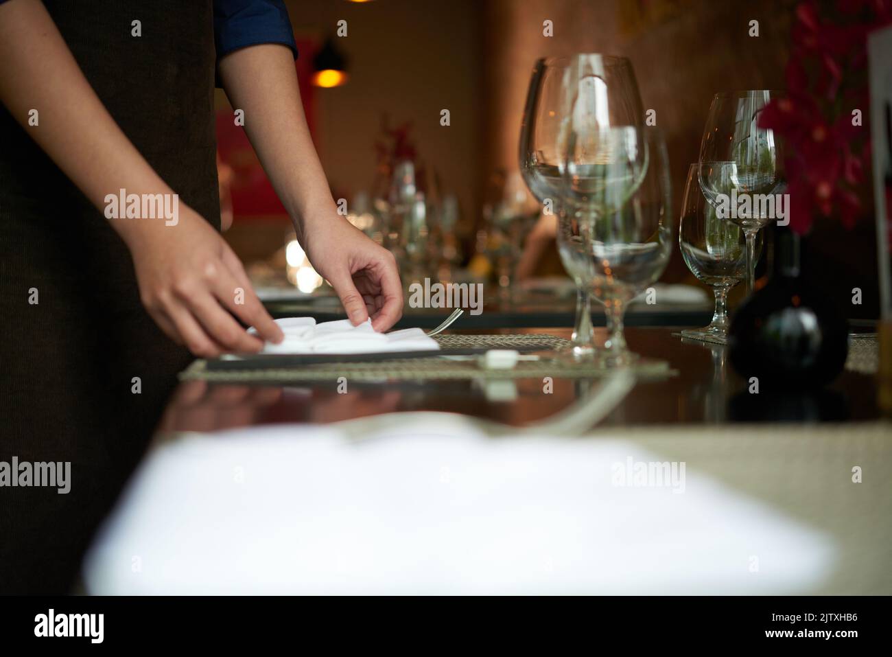 Hands of waiter setting table in restaurant Stock Photo - Alamy