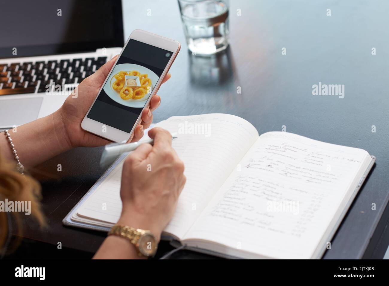 Cafe owner writing down ideas for food delivery application Stock Photo ...