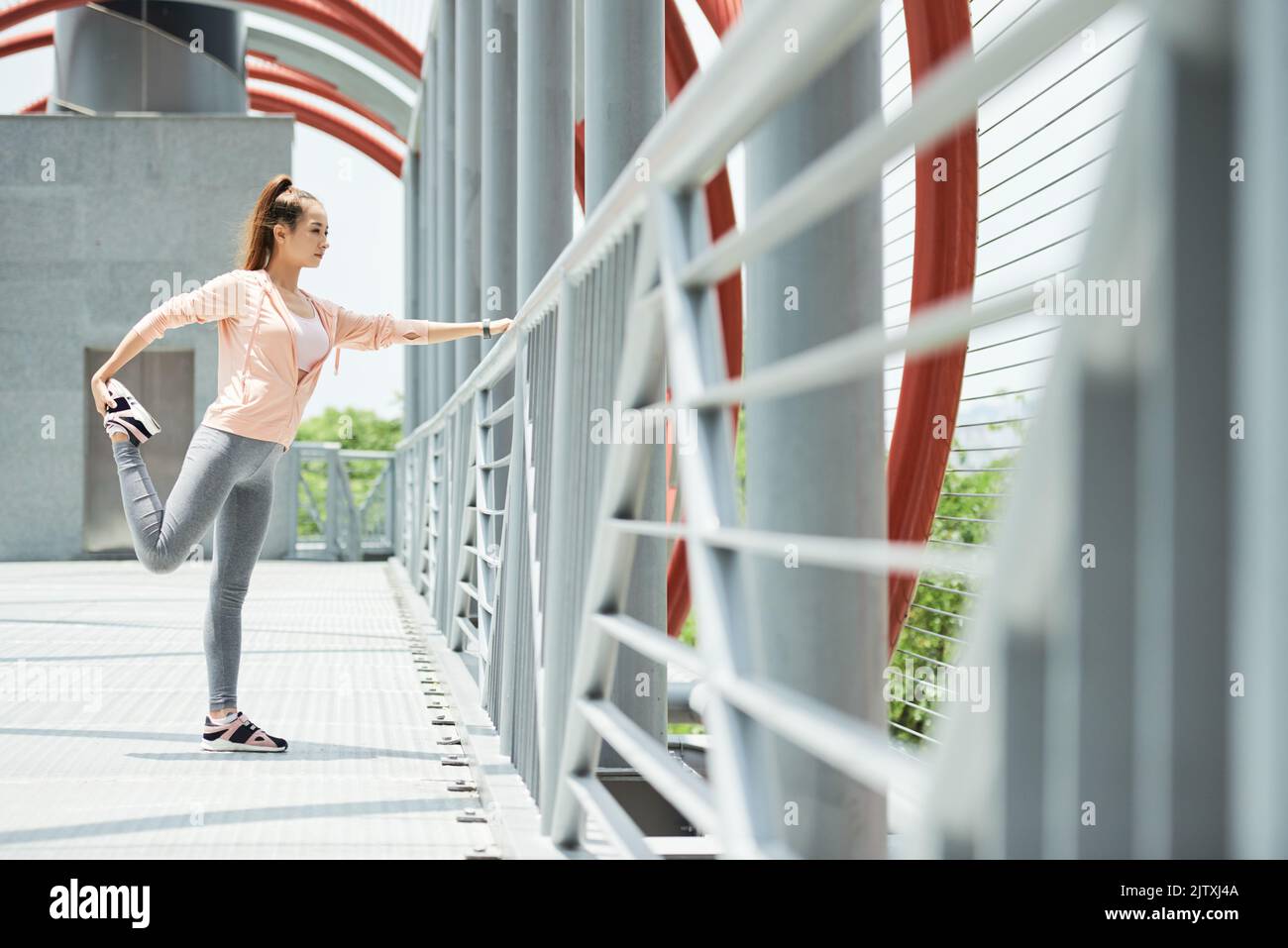 Pretty fit woman stretching legs after working out Stock Photo - Alamy