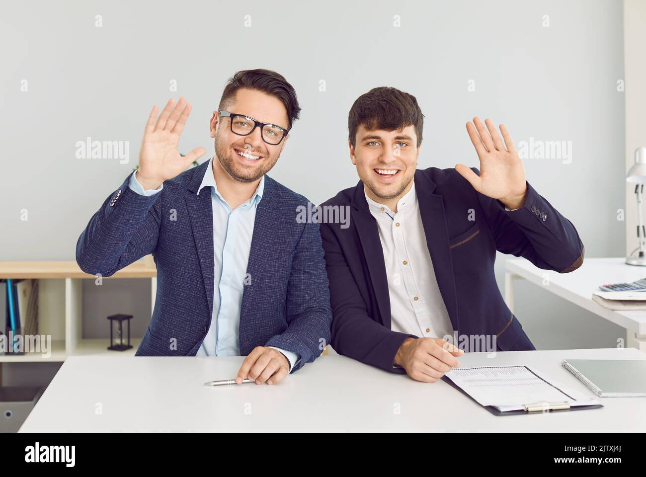 Two People Waving Hello