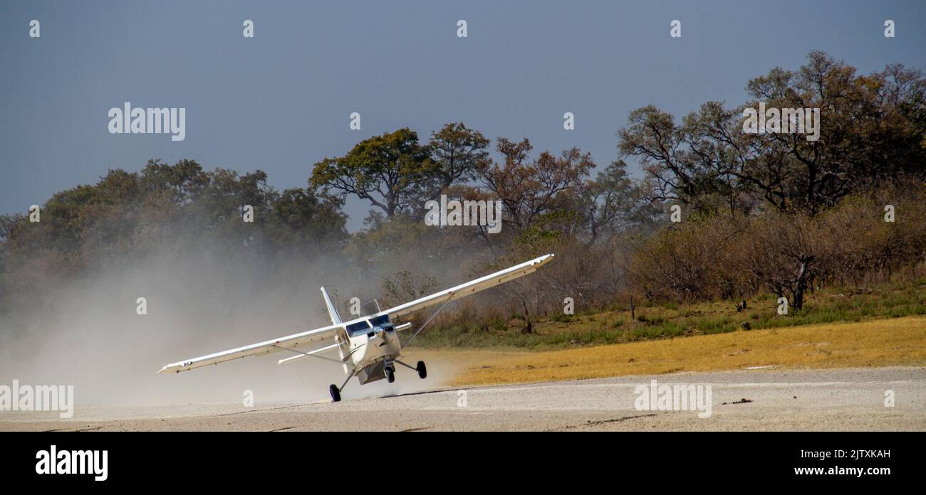 Maun, Botswana - small aircraft taking off on a sand airstrip in rural ...