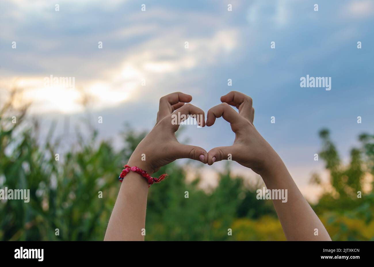 The child makes a heart with his hands. Selective focus Stock Photo - Alamy