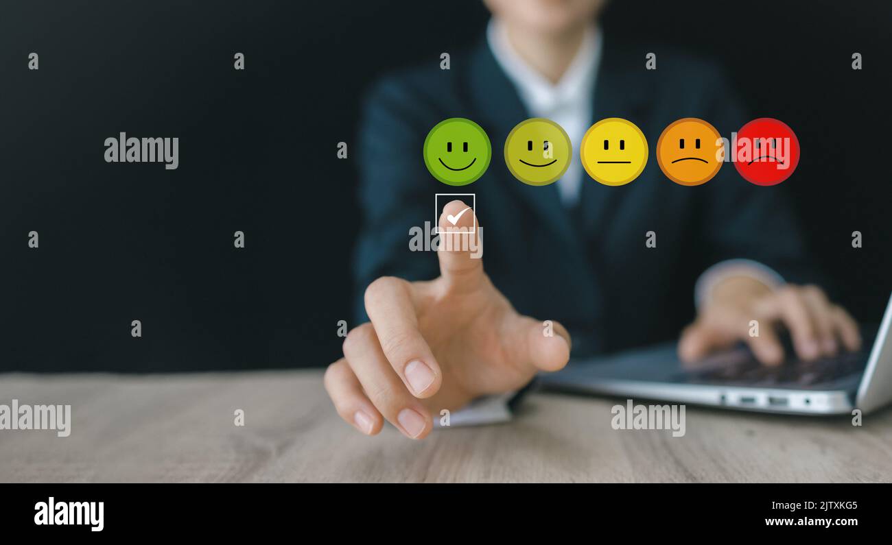 customer services best, Hand of a businessman chooses a smiley face ...