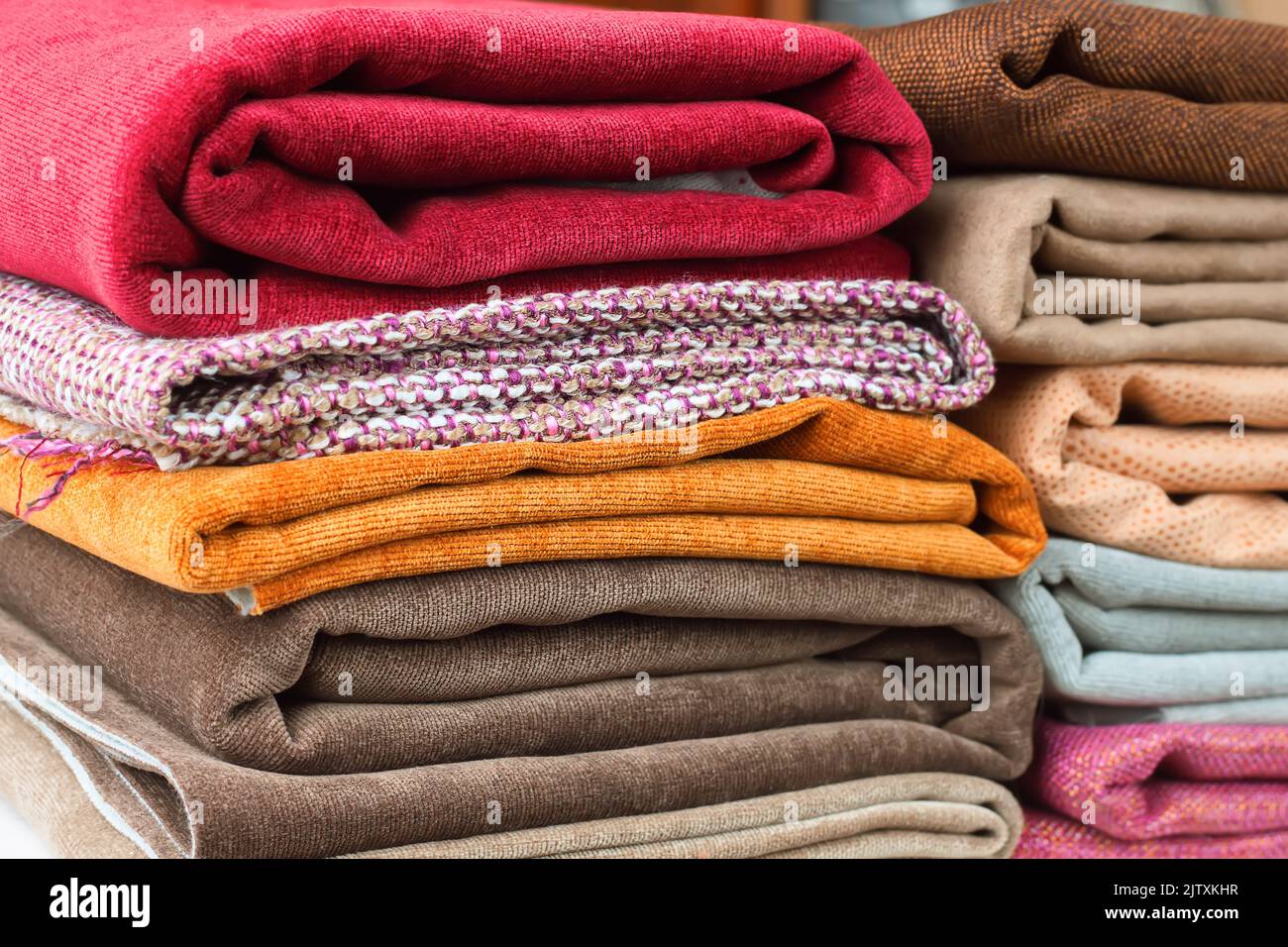 Pile of folded colorful textile. Heap of cloth fabric Stock Photo - Alamy
