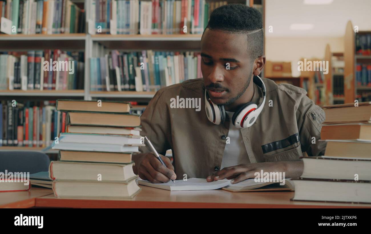 African guy reading in library hi-res stock photography and images - Alamy