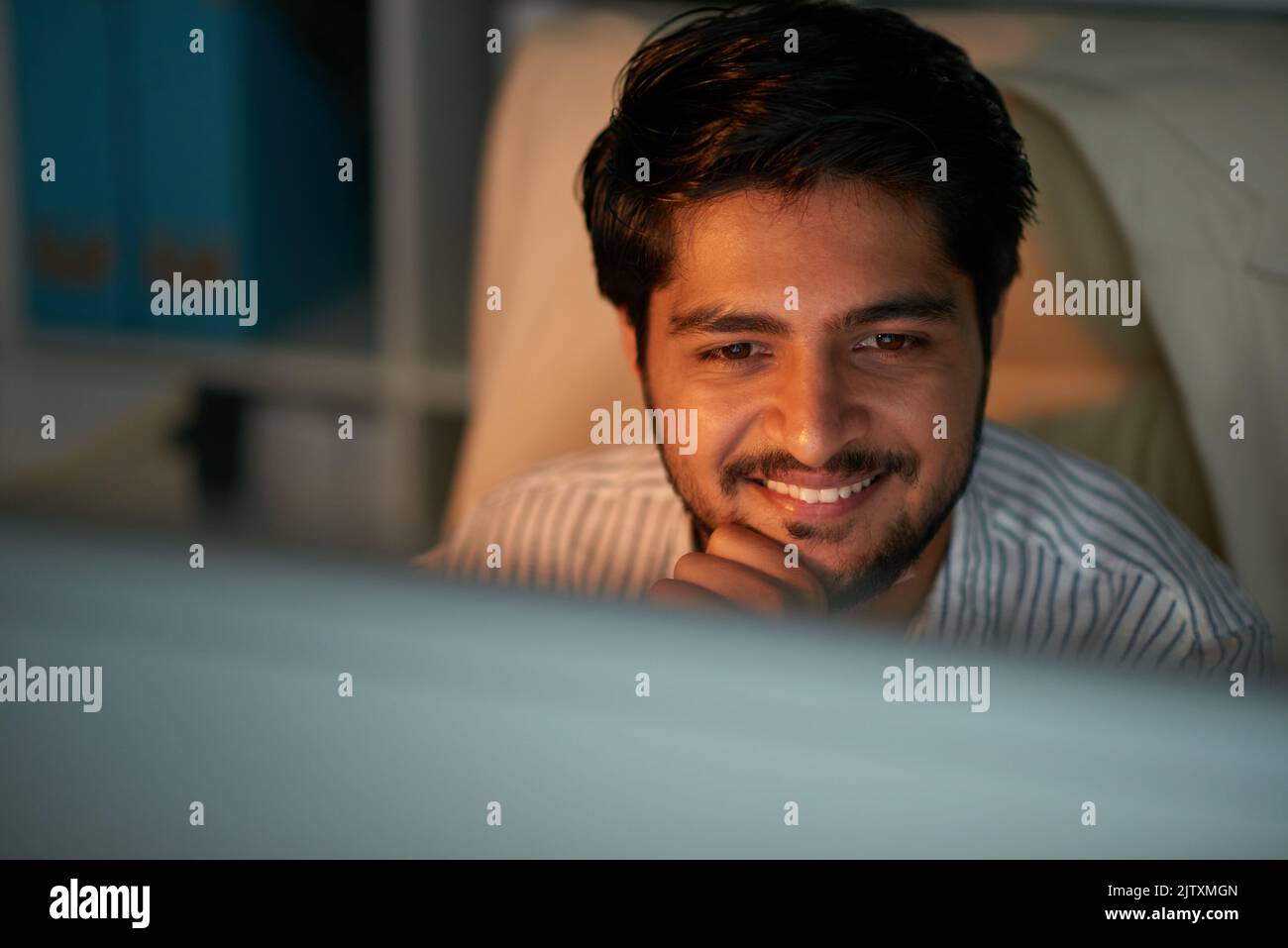 Smiling young Indian entrepreneur reading e-mails Stock Photo - Alamy