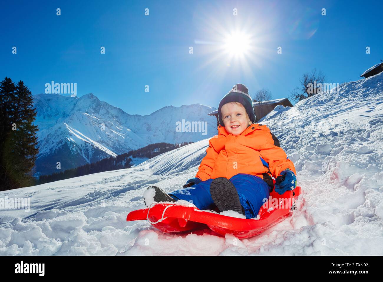 Boy sledging down hill hi-res stock photography and images - Alamy