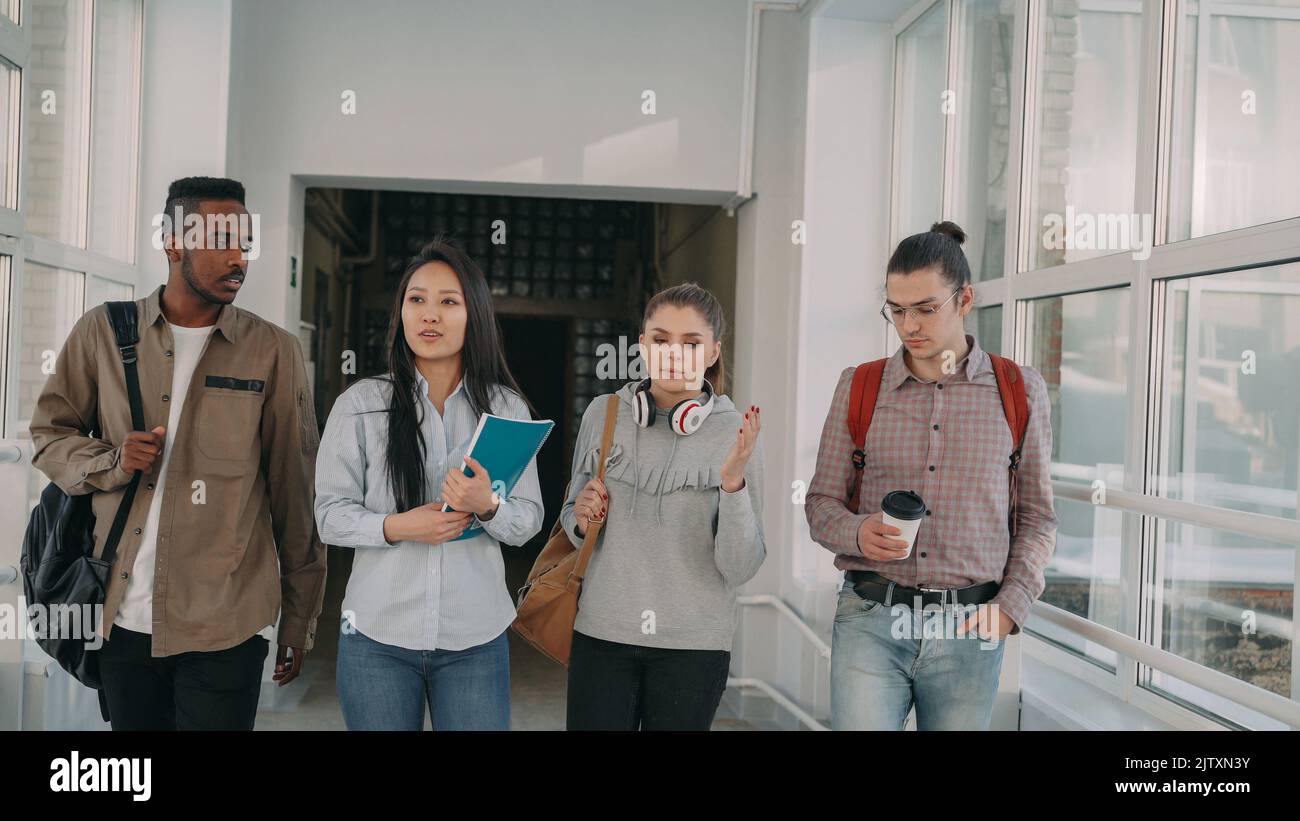 Four serious concentrated male and female students of different ...