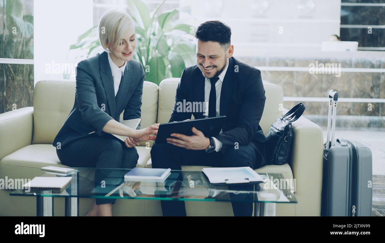 Two female and male business colleagues using digital tablet, notepad ...