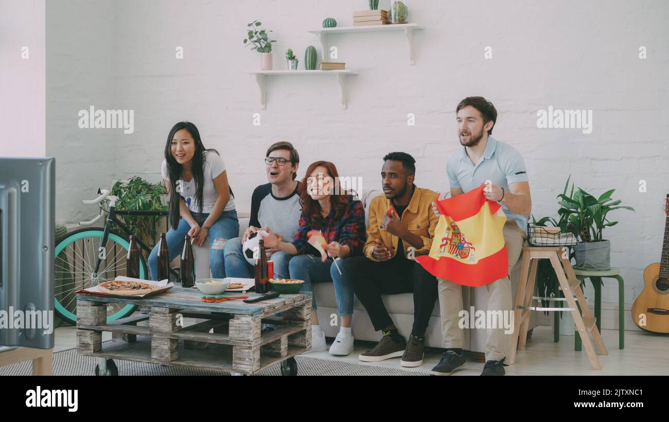 Multi-ethnic group of friends sports fans with Spainsh flags watching ...