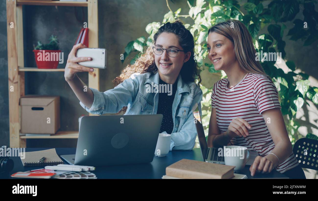 Young enterpreneurs are talking and making selfie with smart phone ...