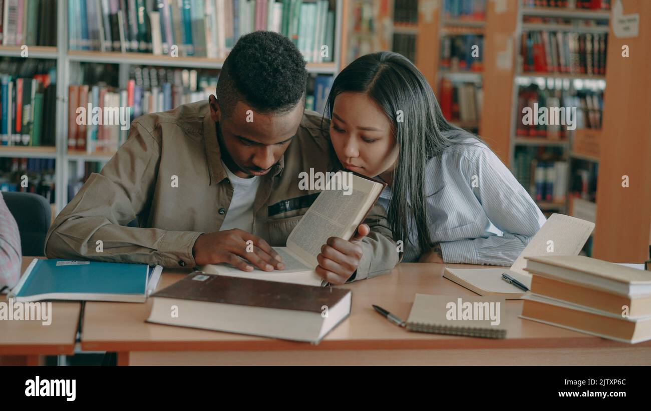 diligent biracial students preparing for exams doing homework in ...
