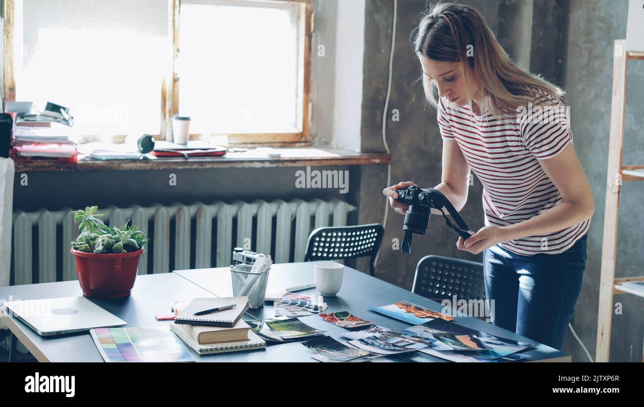 Young attractive female blogger using digital camera to shoot colourful ...