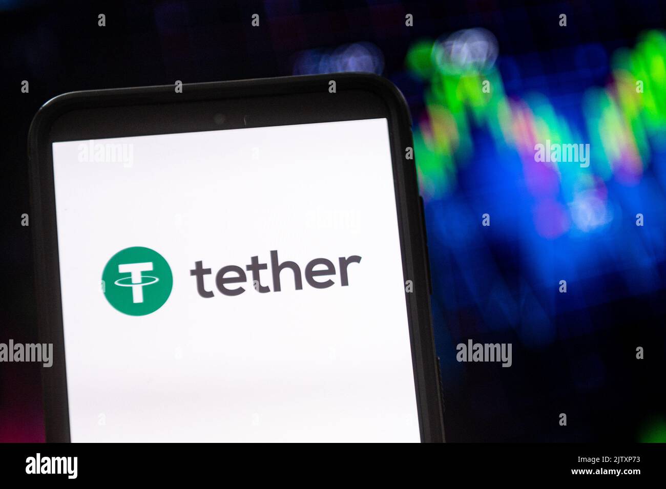 In this photo illustration a Tether logo seen displayed on a smartphone ...