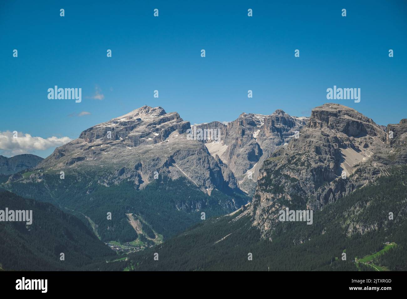 An aerial view of beautiful mountains against a blue sky surrounded by ...