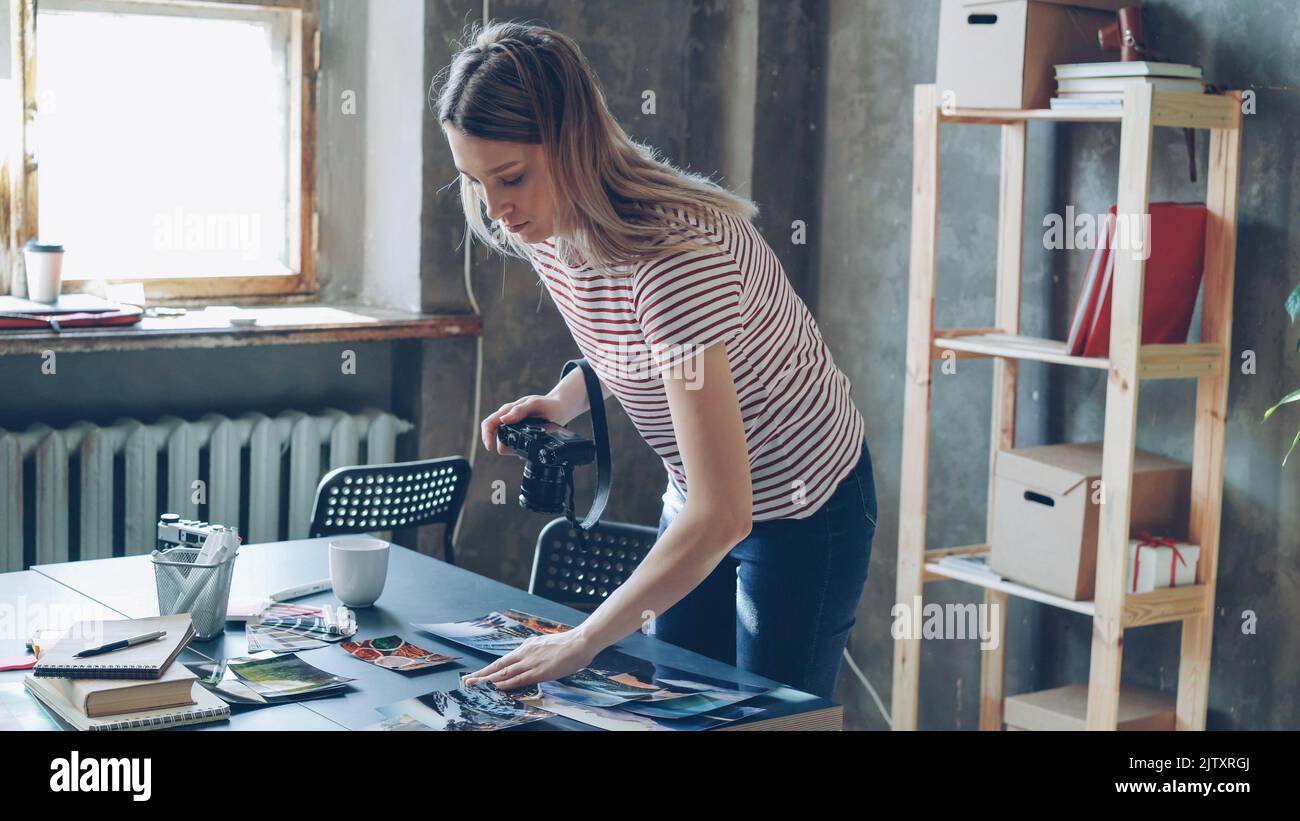 Young attractive female blogger using digital camera to shoot colourful ...