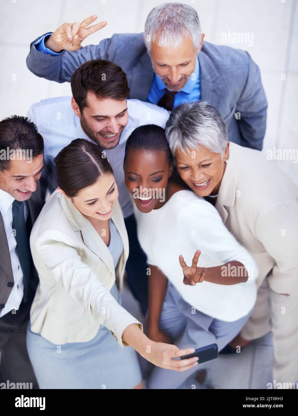 Lets do a fun team photo. Shot of a diverse group of businesspeople ...