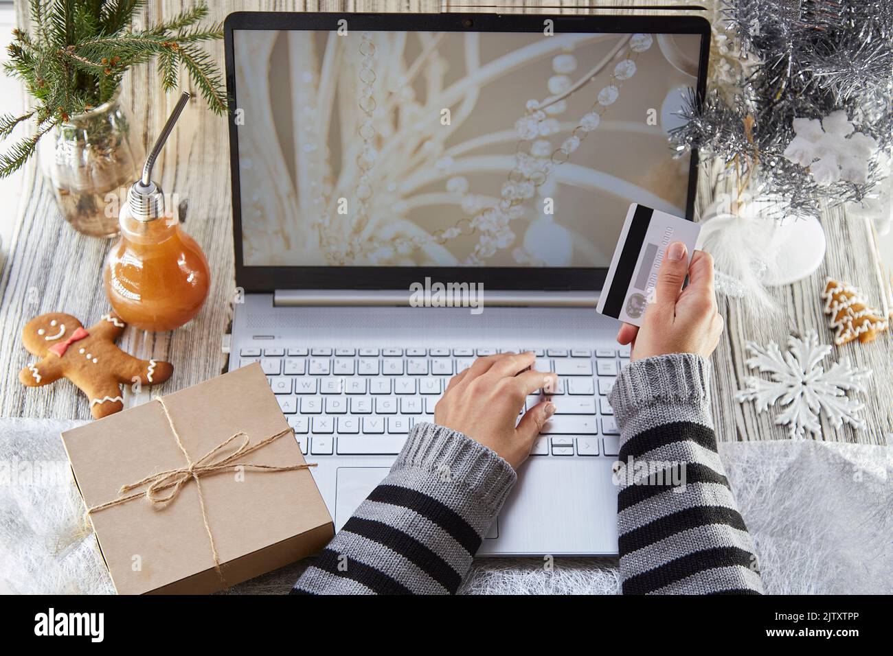 Woman searching and buying Christmas holidays gift online by laptop ...
