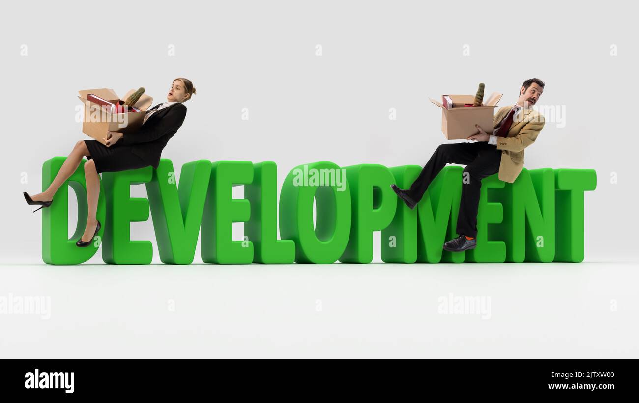 Two people, employees, man and woman with carton boxes filled with ...