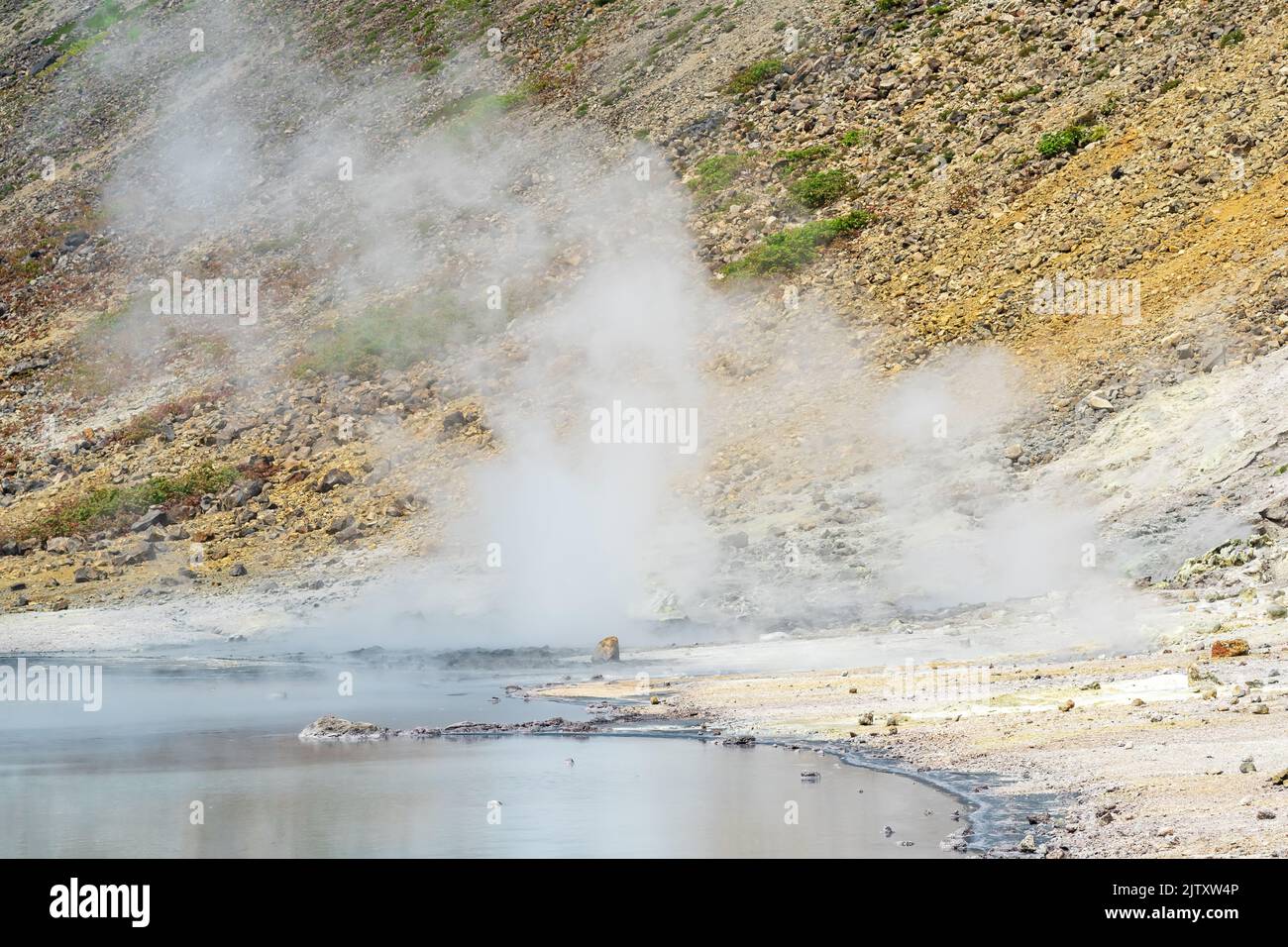 hot hydrothermal water outlet on the shore of the lake in the caldera ...