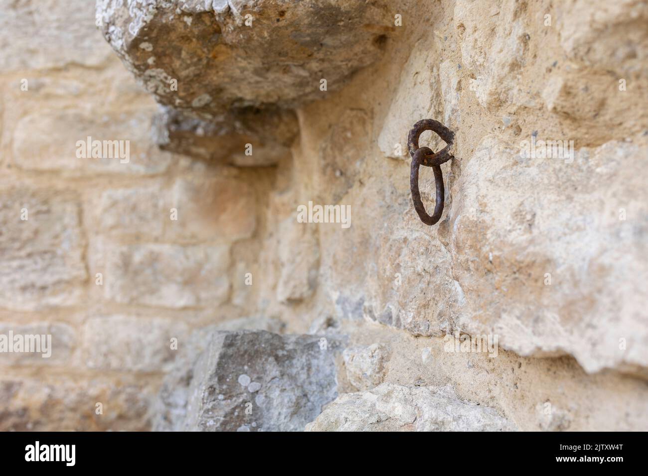 Old rusty iron ring in an ancient sandstone castle wall, selective ...