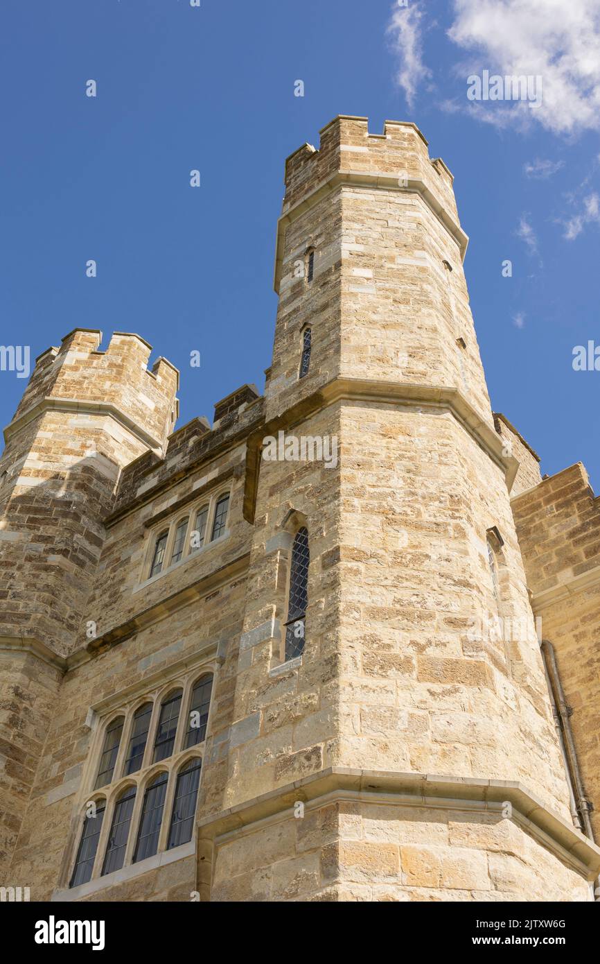view of a english sandstone medieval castle looking up a turret towards ...