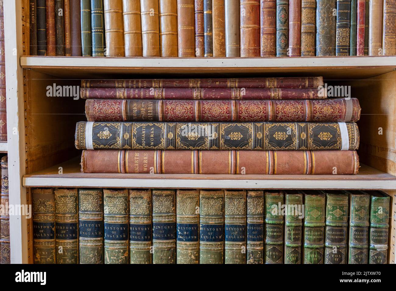 Old books on wooden shelf. Concept on the theme of history, nostalgia, old age. Retro style ...