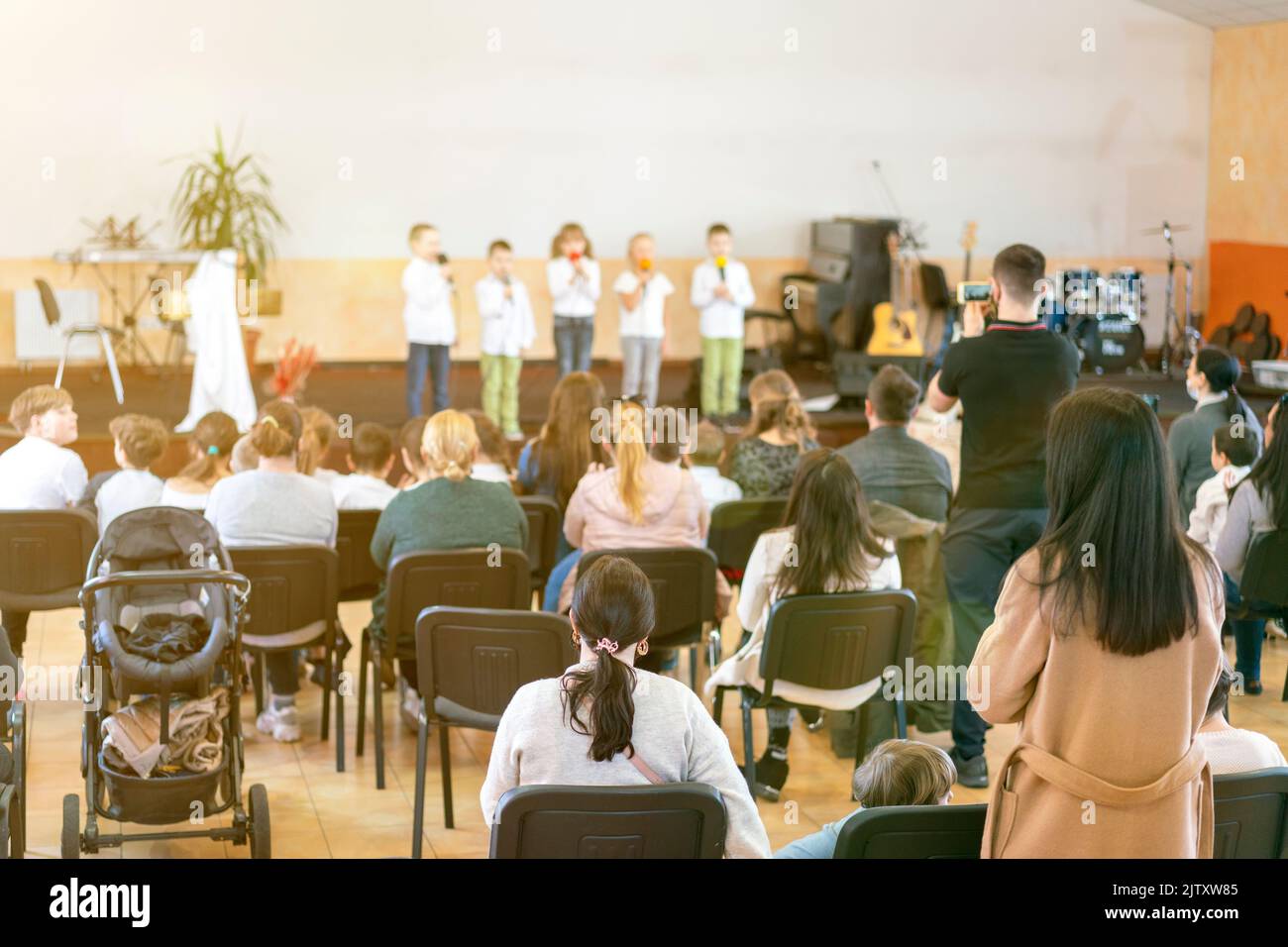 Children on the stage. Children on stage perform in front of parents ...