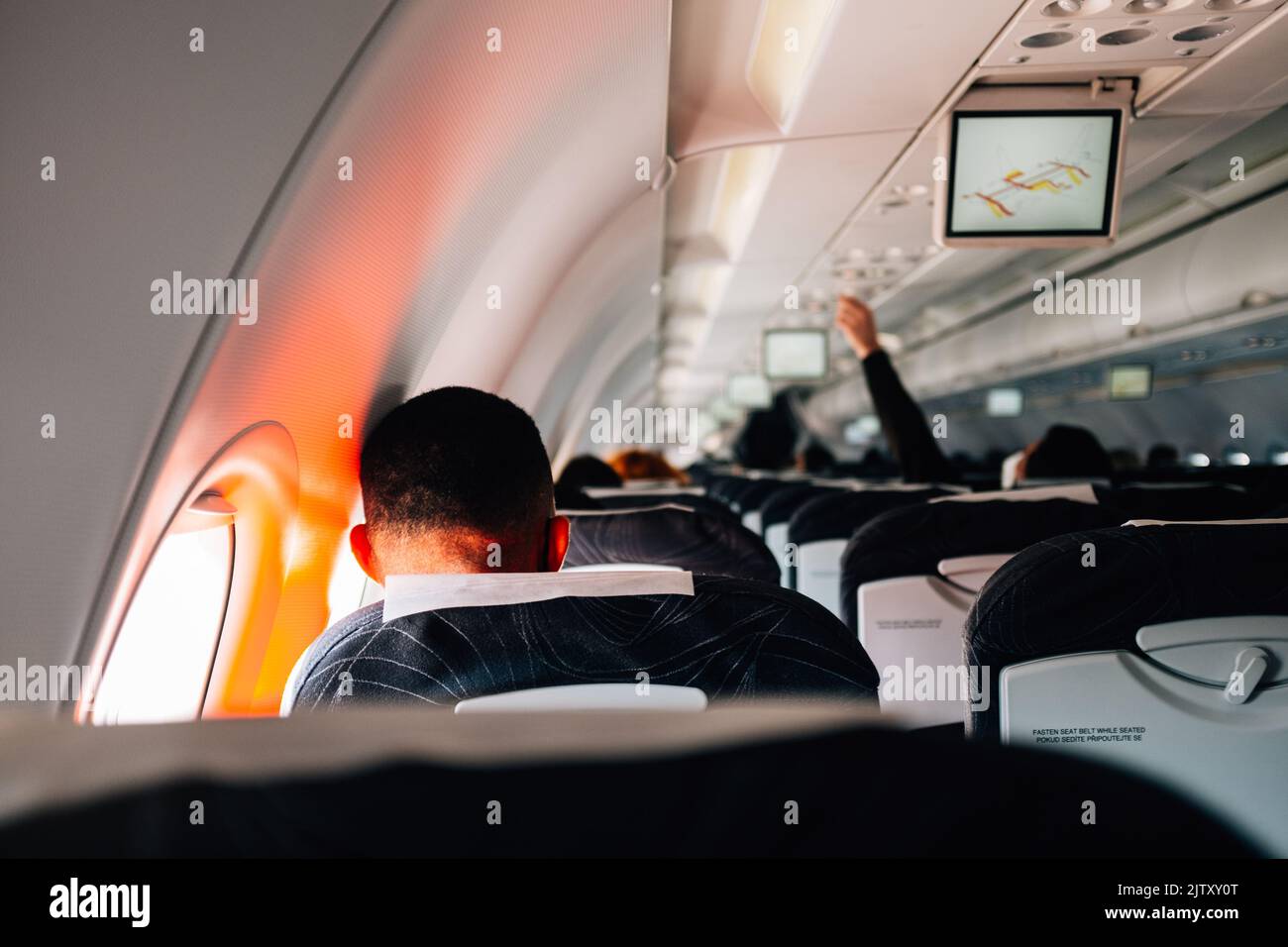 The back of people's heads as they wait for takeoff on a commercial ...