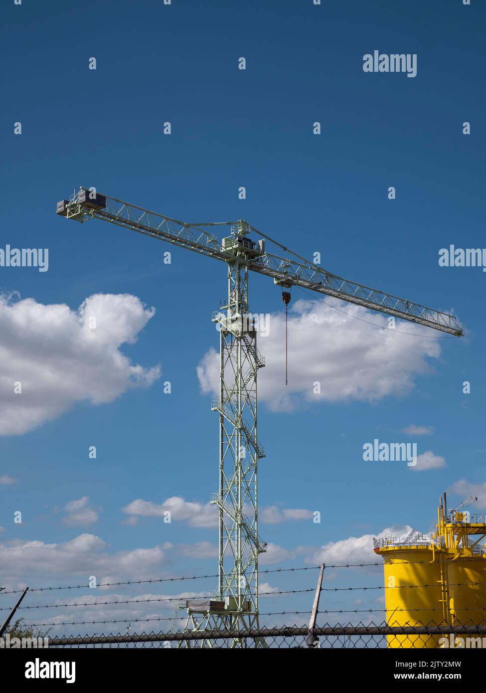 Large industrial crane with iron stairs and a blue cloudy sky Stock ...