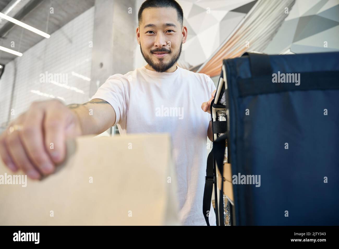Lovely local cafe employee providing food delivery service Stock Photo ...