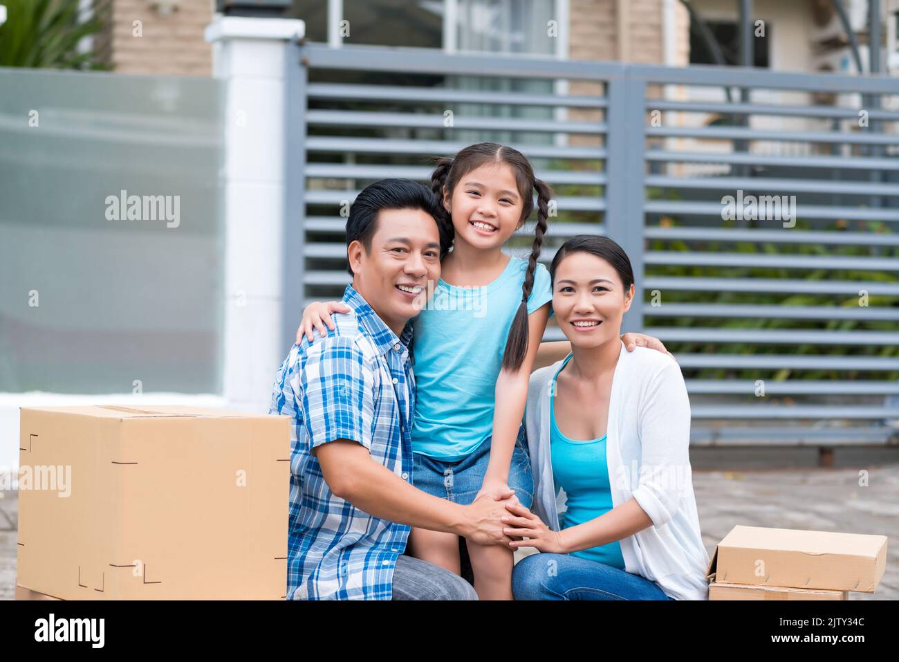 Family standing in front of house hi-res stock photography and images ...