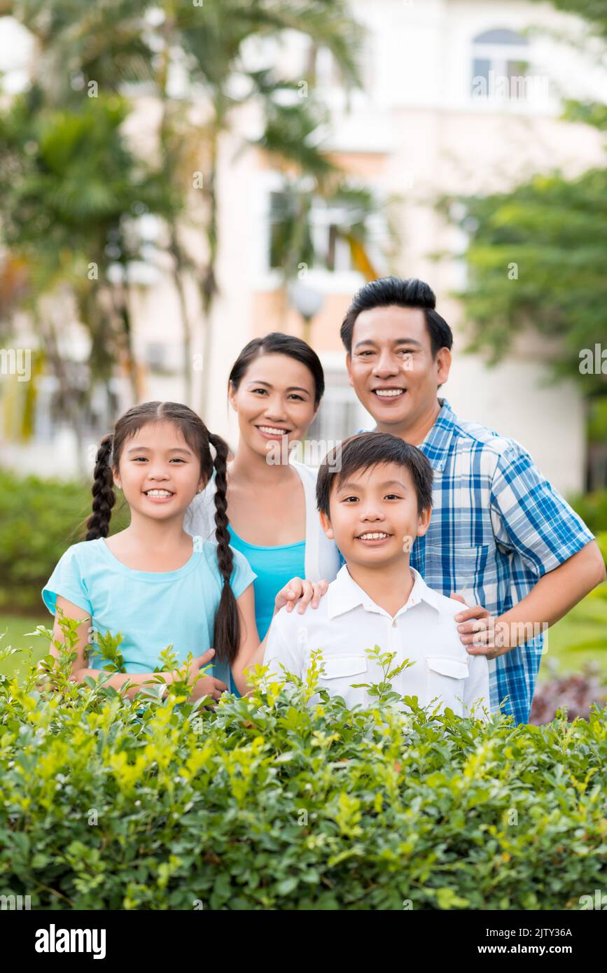 Portrait of Asian family of four standing outdoors Stock Photo - Alamy