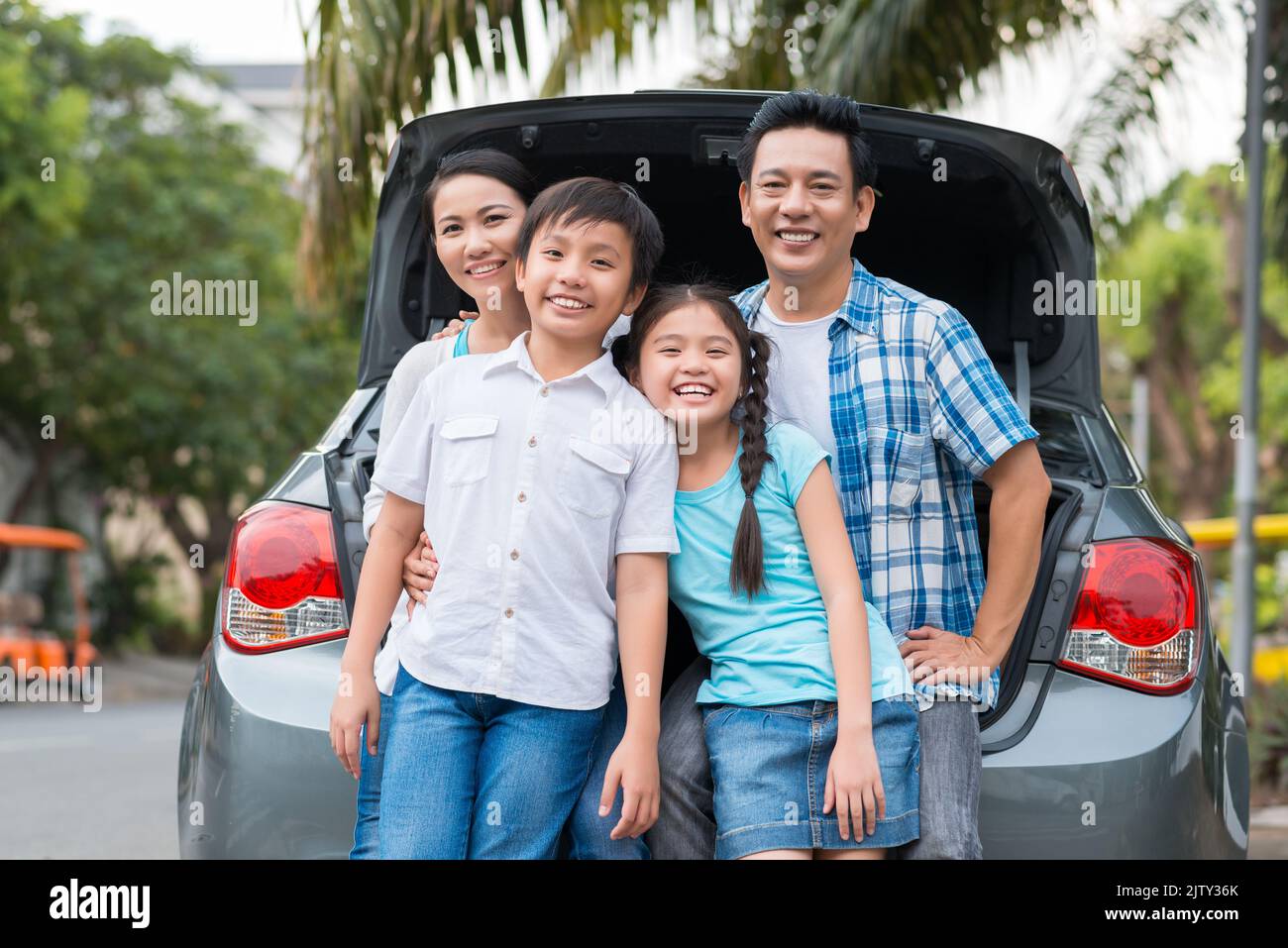 Portrait of happy Asian family standing near the car Stock Photo - Alamy