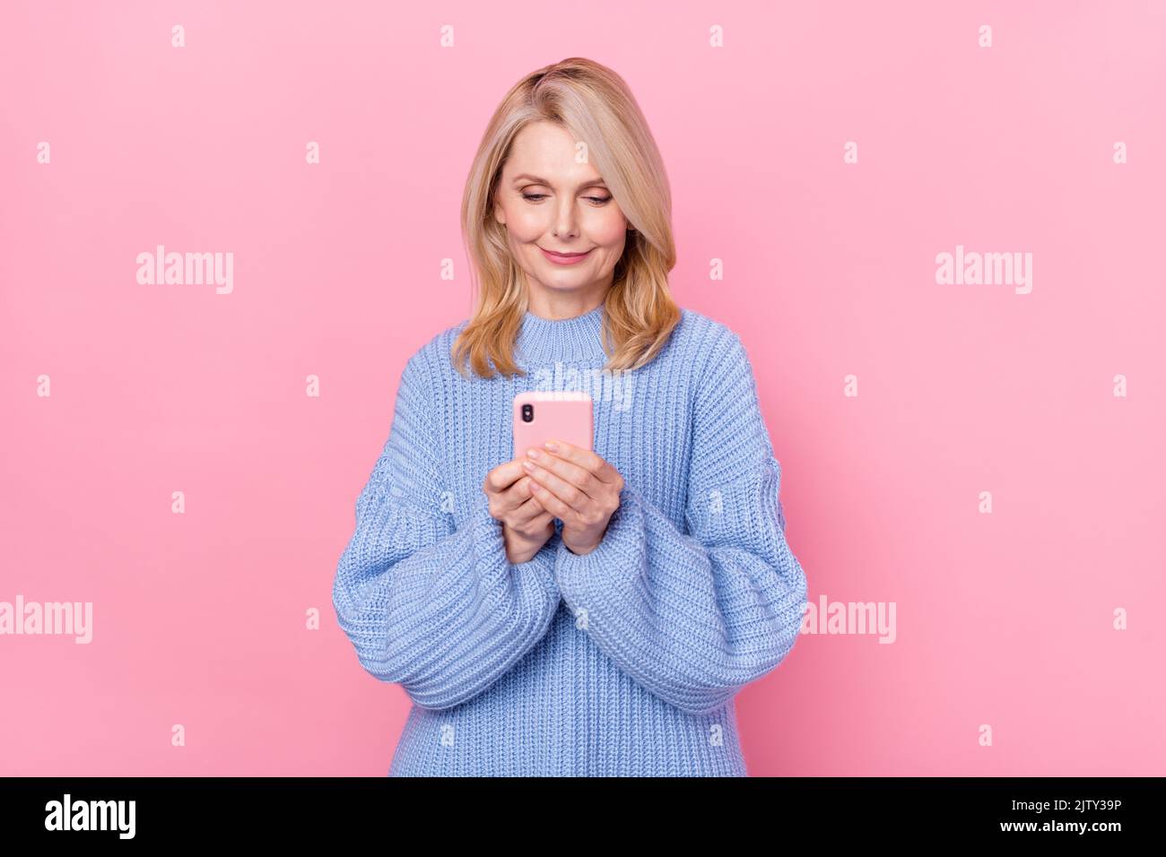 Photo of funky senior blond lady look telephone wear blue sweater ...