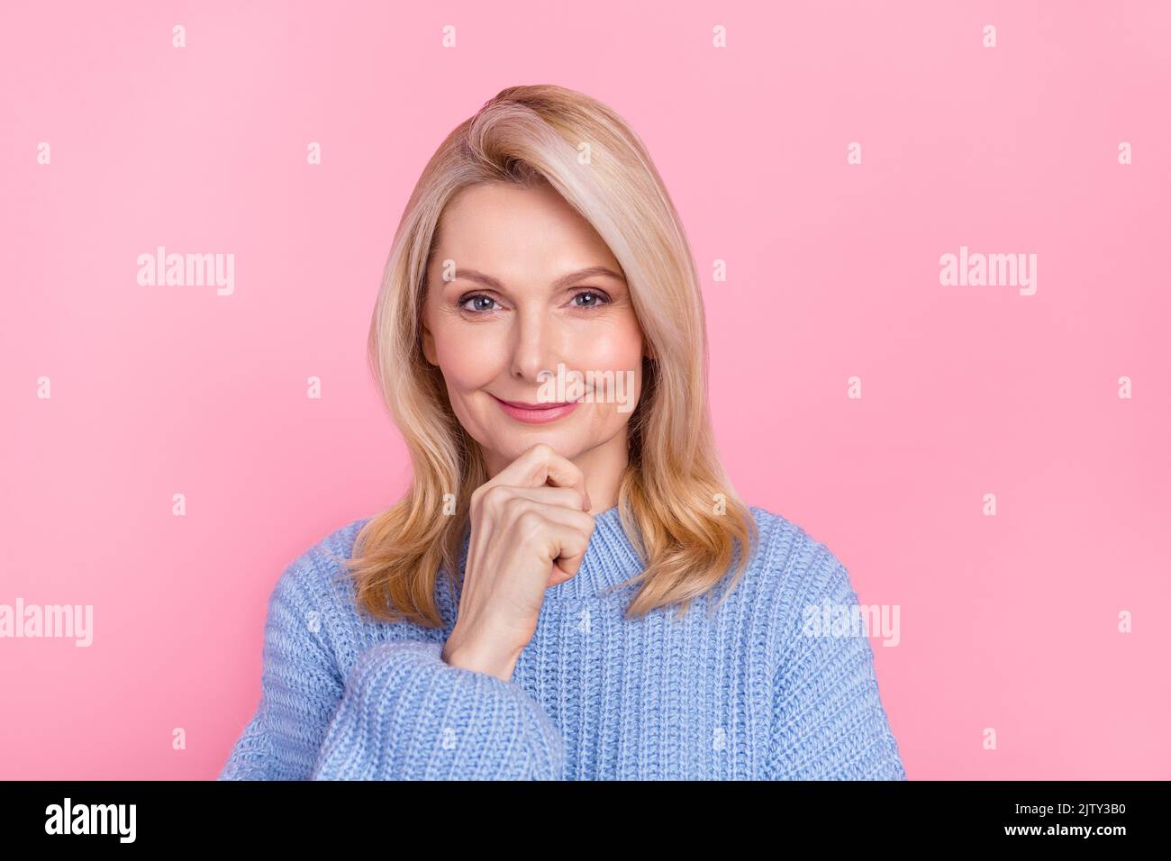 Photo of mature think blond lady hand face wear blue pullover isolated ...