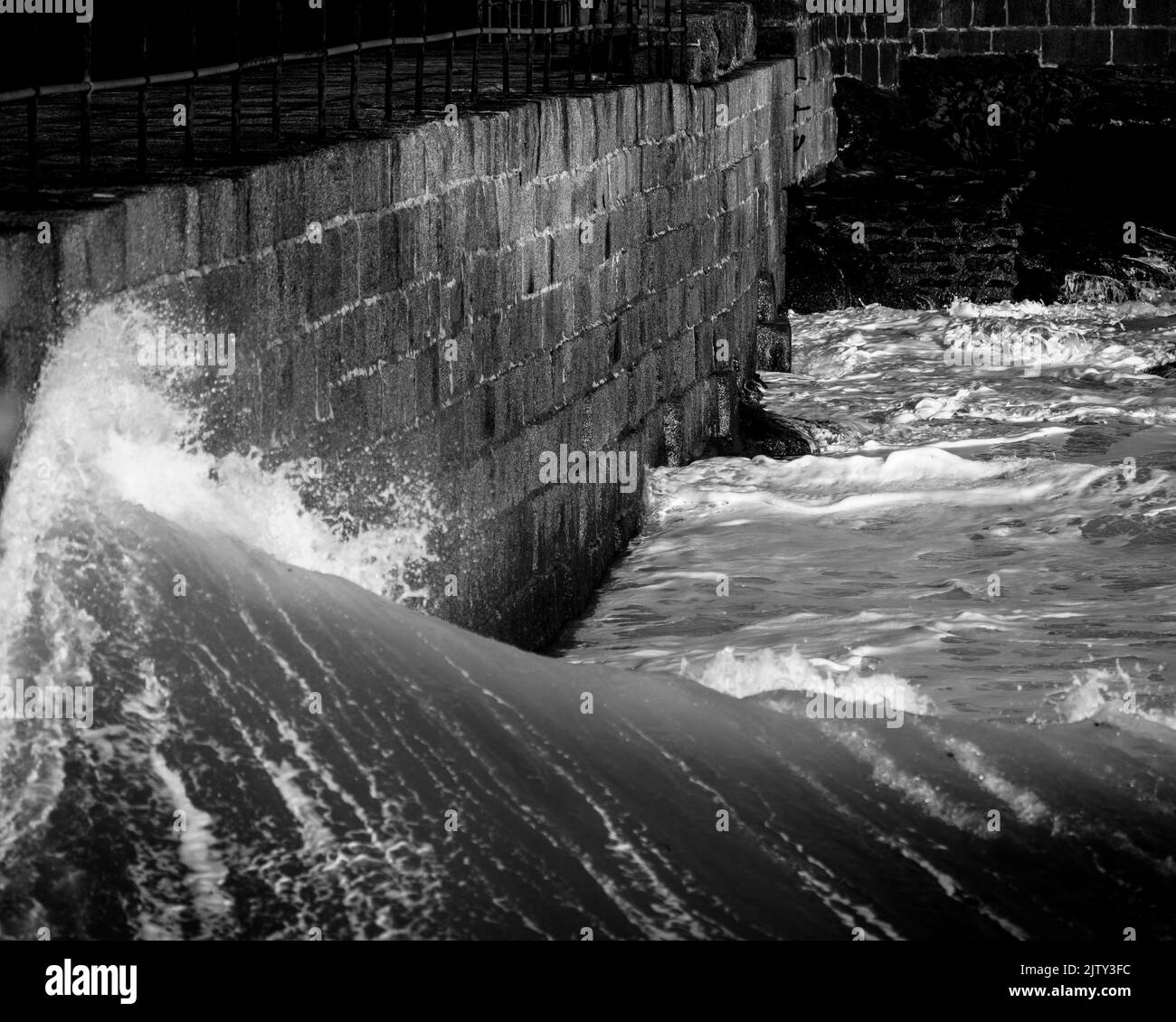 Large waves smashing into and over Porthleven pier Stock Photo - Alamy