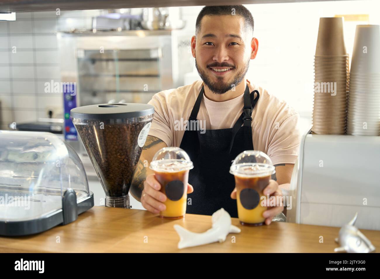 Cute young barista delivering delicious beverages with a smile Stock ...