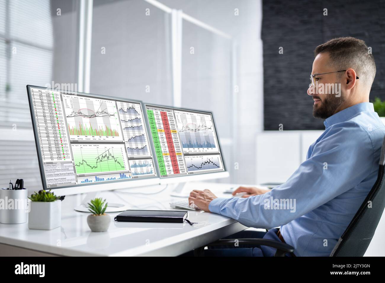 Stock Market Analyst At Office Desk Using Multiple Screens Stock Photo ...
