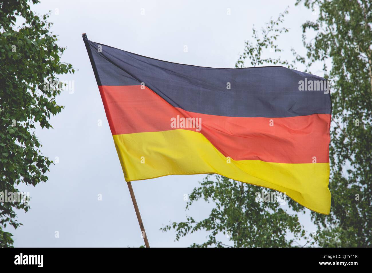 A closeup of the German flag hanging and waving around a pole Stock ...
