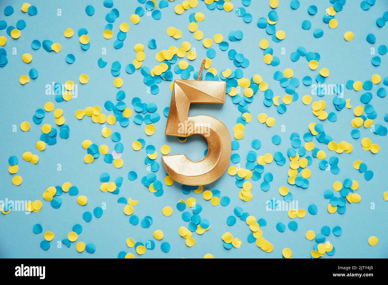 Number 5 five golden celebration birthday candle on yellow and blue ...