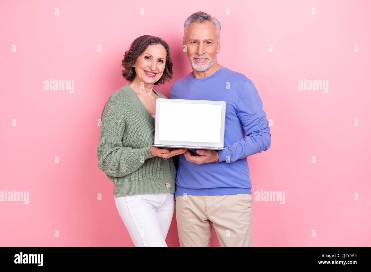 Portrait of two handsome beautiful cheery people holding laptop copy ...