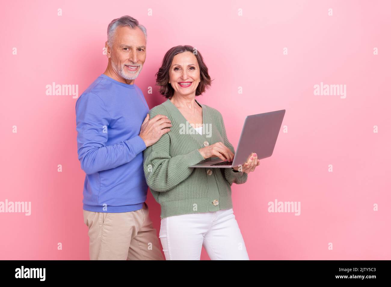 Portrait of two handsome beautiful people using laptop typing text ...