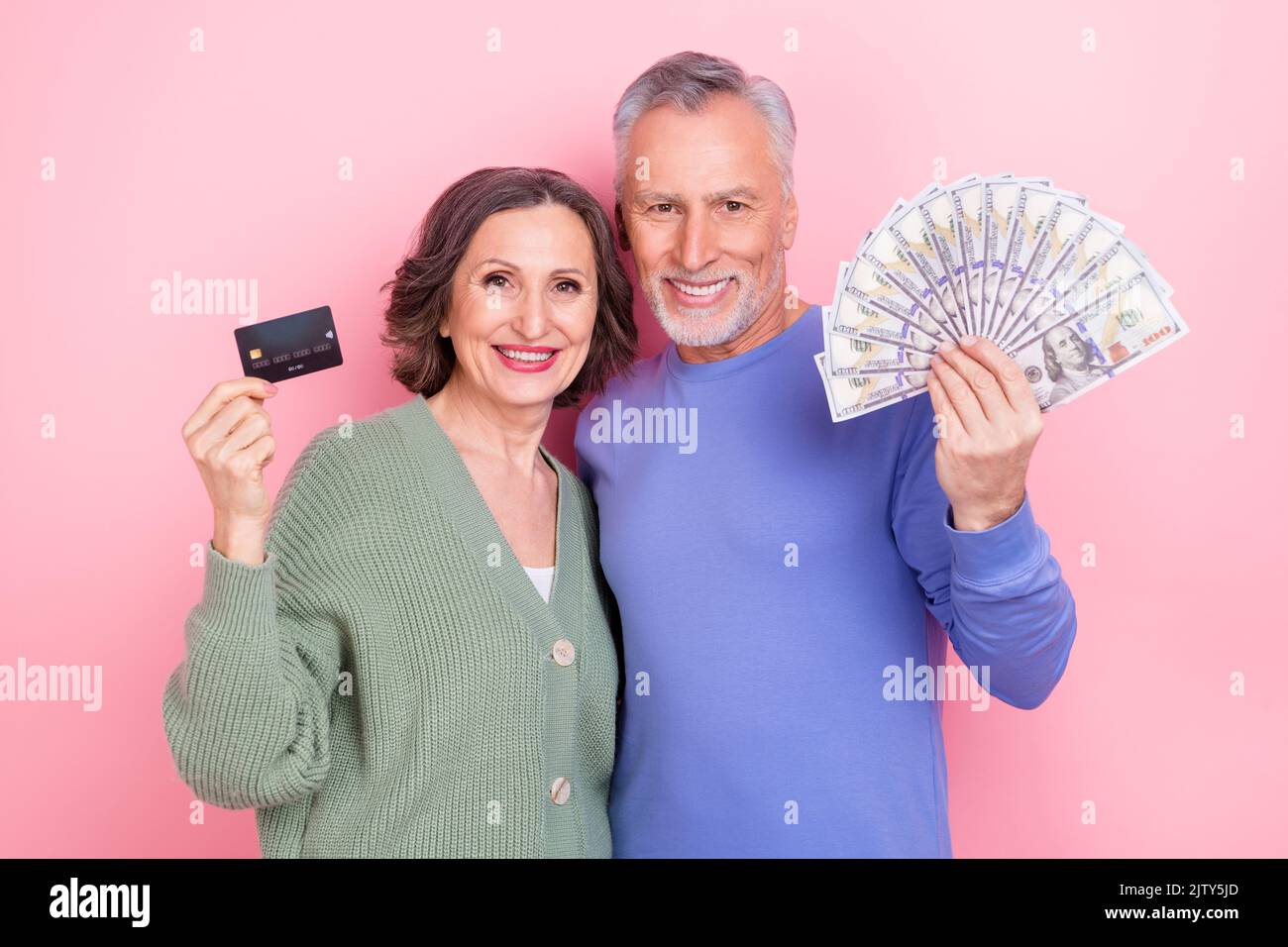 Photo of two glad positive partners hold plastic debit card hundred ...